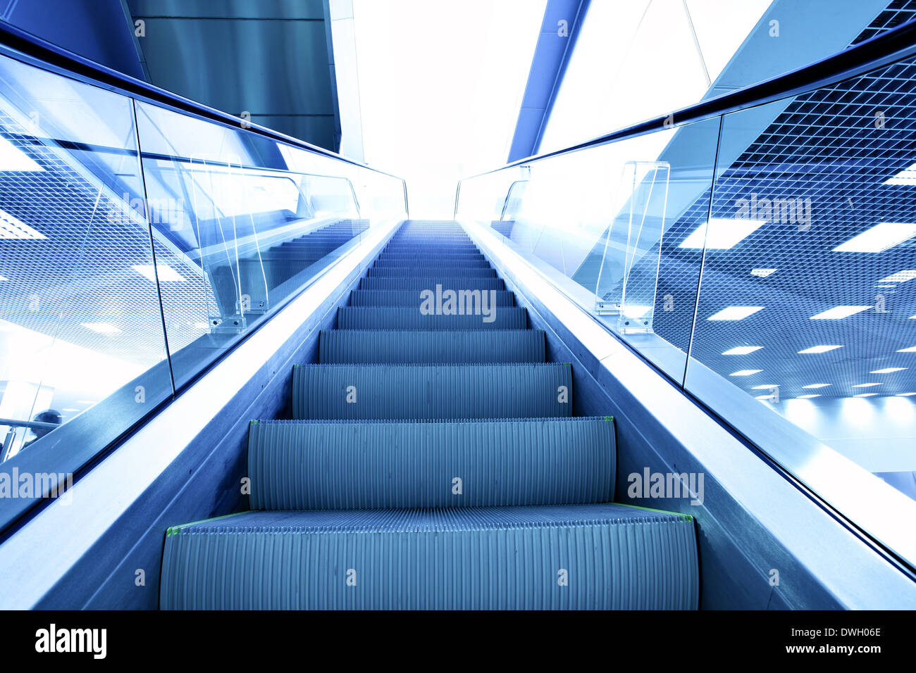 Perspective of escalator toned in blue color Stock Photo - Alamy