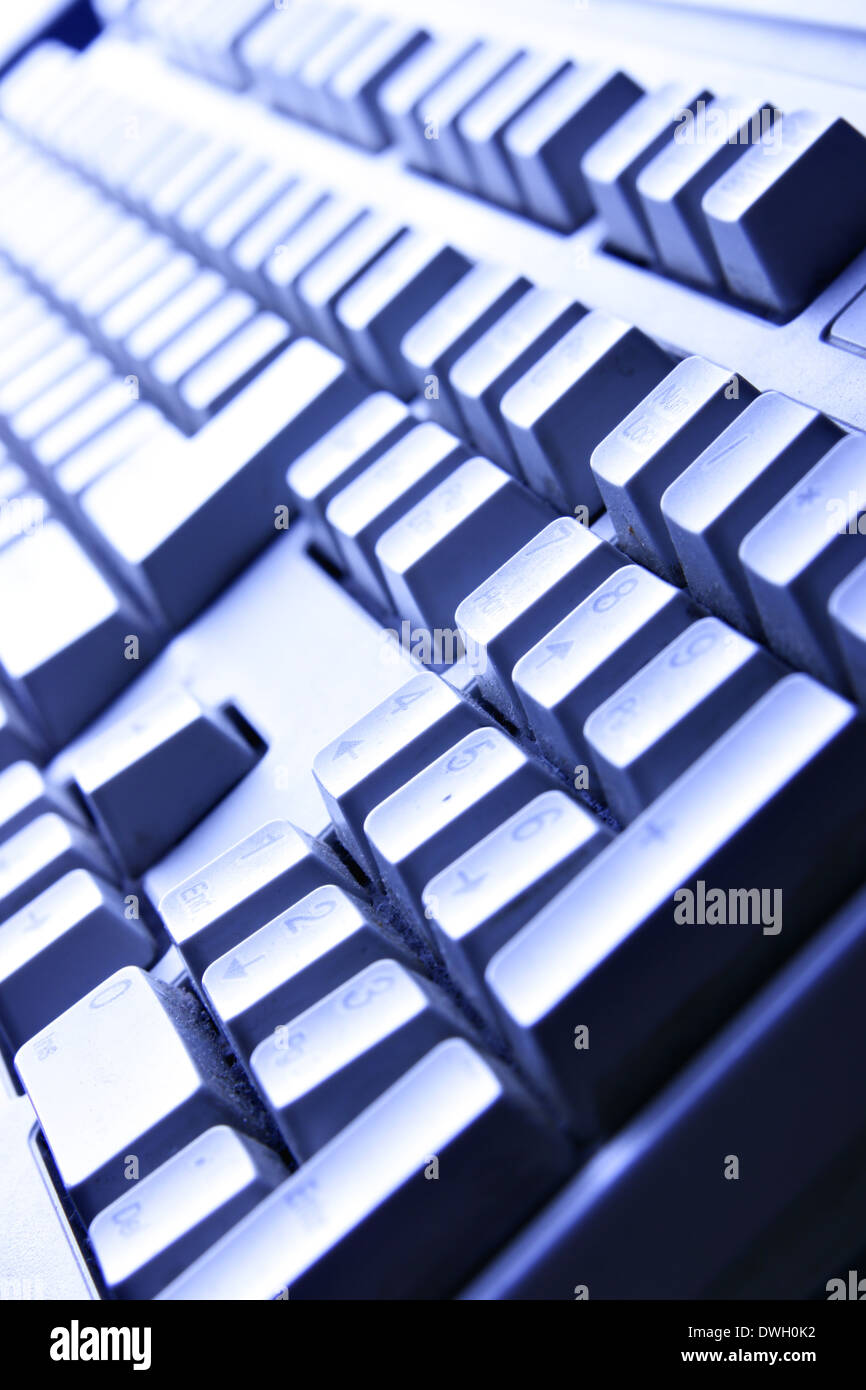 Computer keyboard close up in blue light Stock Photo - Alamy