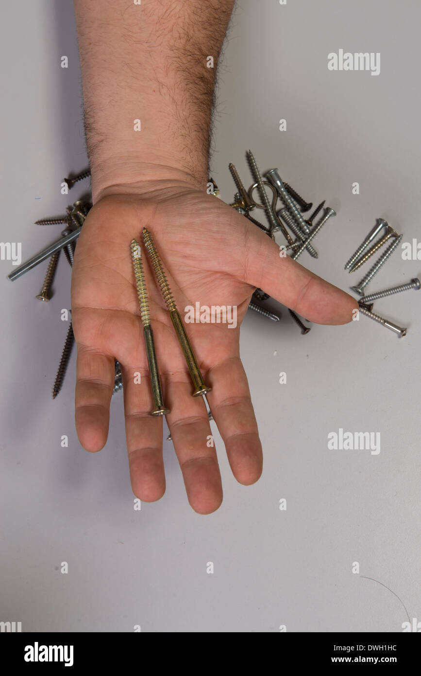Hand playing with small hardware Stock Photo - Alamy