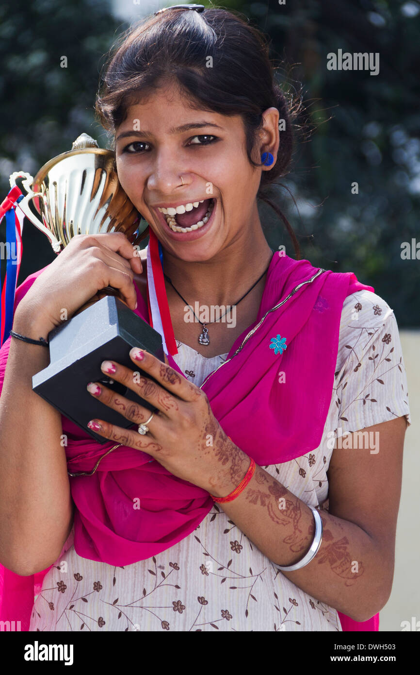 indian rural girl standing with trophy at home Stock Photo - Alamy