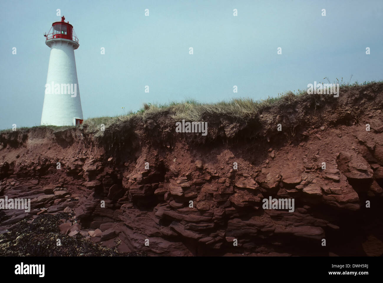 Oldest lighthouse and red rocks shoreline, Point Prim, PEI, Canada ...