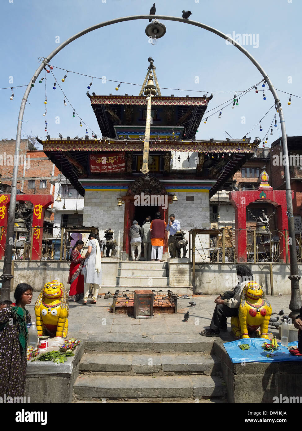 Pilgrims pray at a small temple used by both Hindu and Buddhist ...