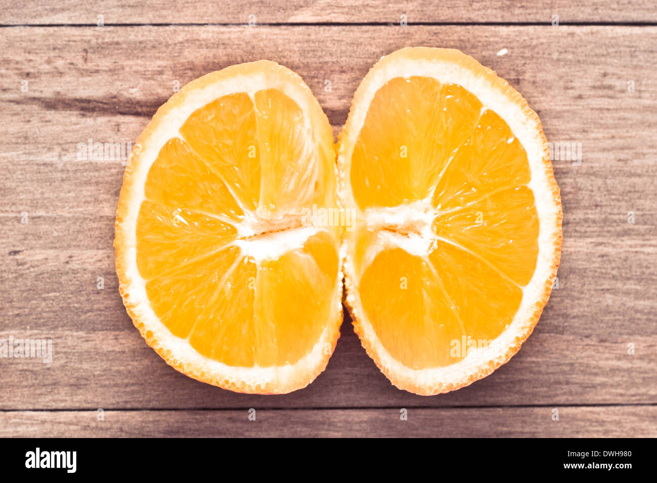 A cut open orange on a wood surface Stock Photo - Alamy