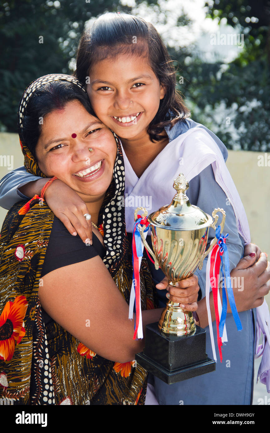 Indian woman giving trophy to kids Stock Photo - Alamy