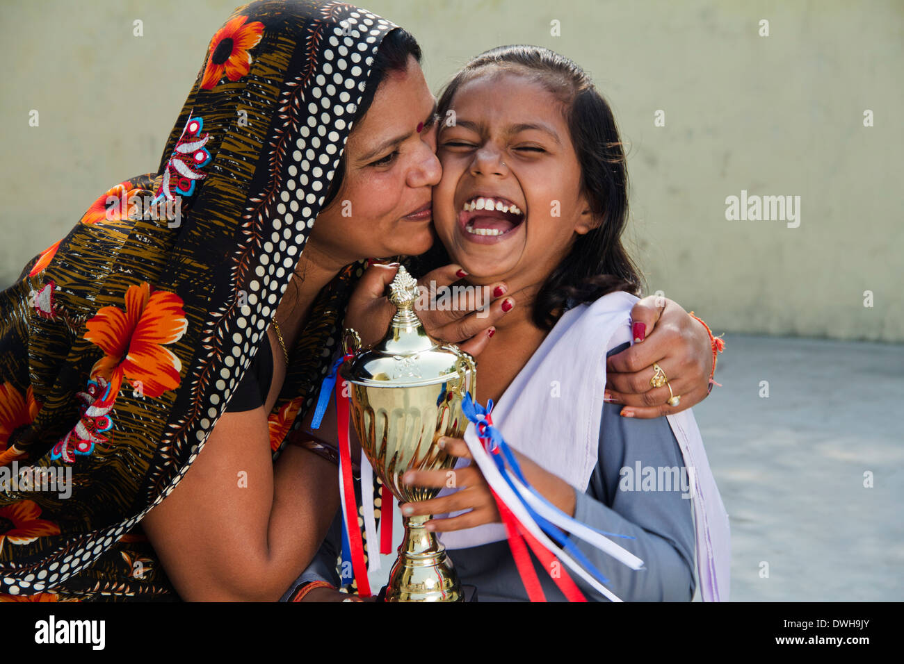 Indian woman giving trophy to kids Stock Photo - Alamy