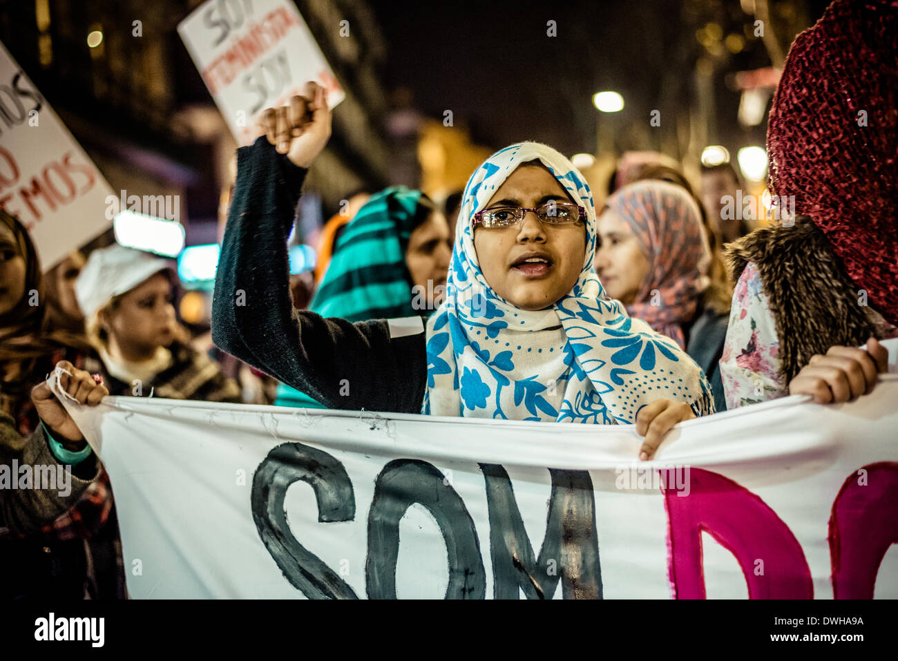 Barcelona, Spain. March 8th, 2014: An activist behind their banner ...