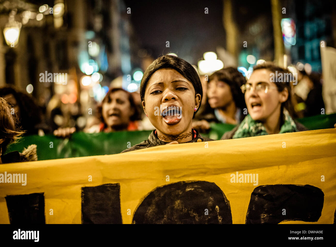 Barcelona, Spain. March 8th, 2014: An activist behind their banner ...