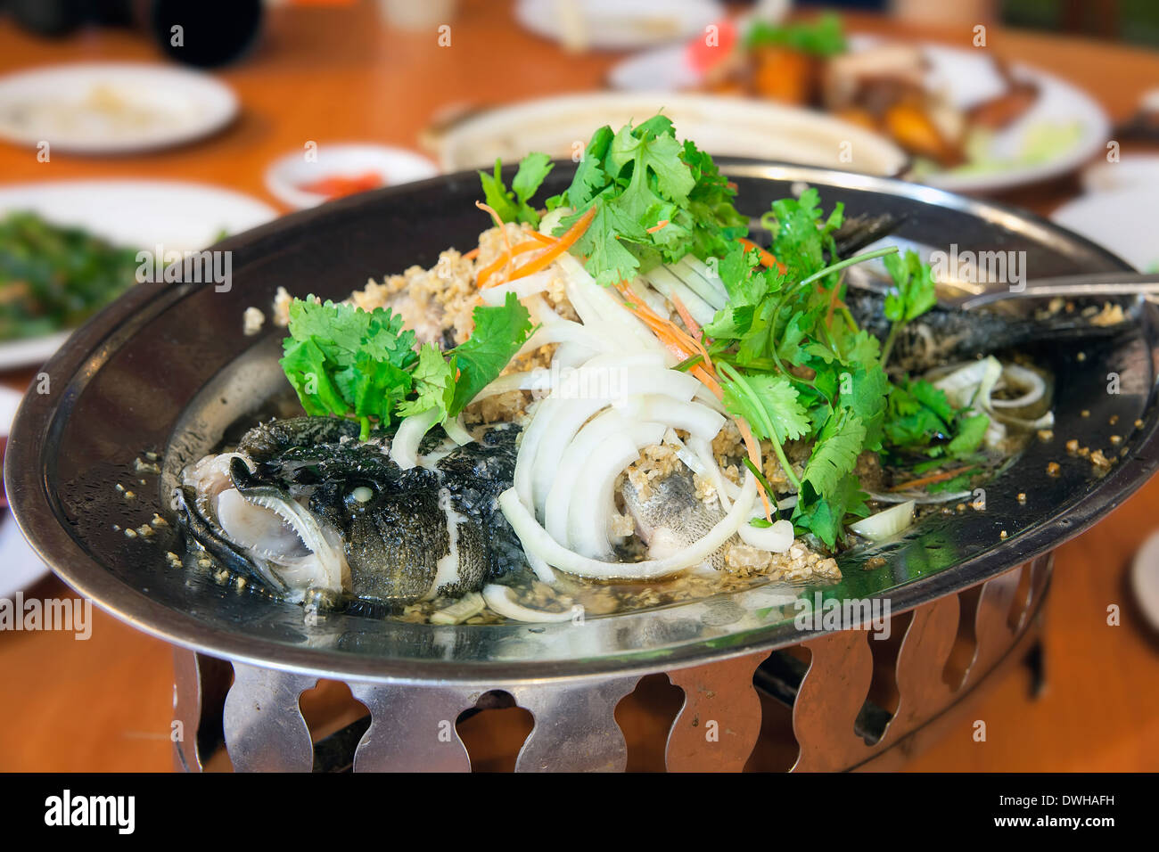 Steam Whole Fish with Garlic and Ginger Garnished with Onions and ...