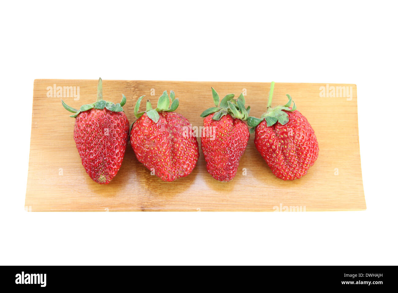 Four Strawberry in bamboo dish on white background Stock Photo - Alamy
