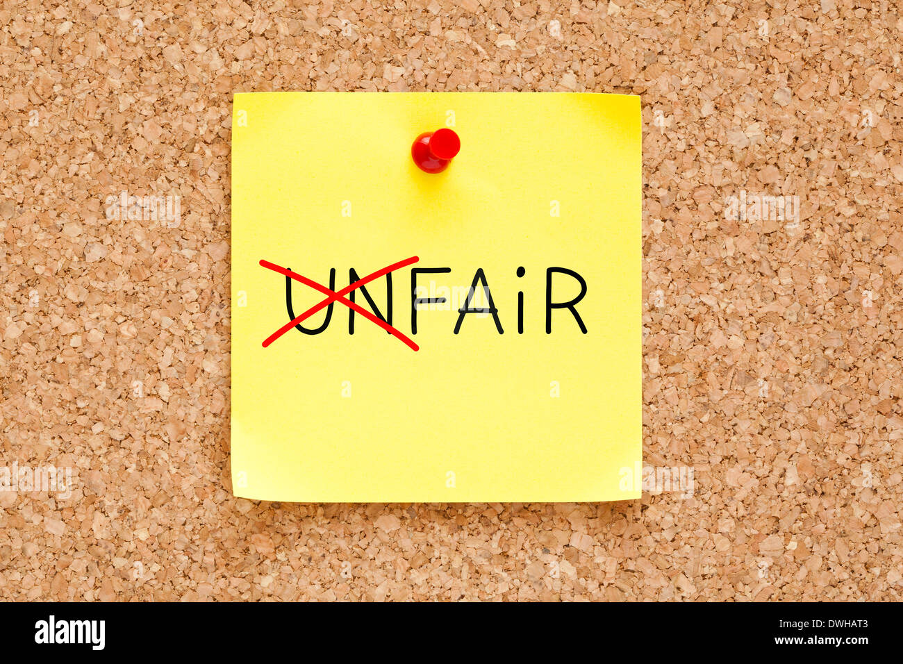 Turning the word Unfair into Fair with red marker on yellow sticky note ...