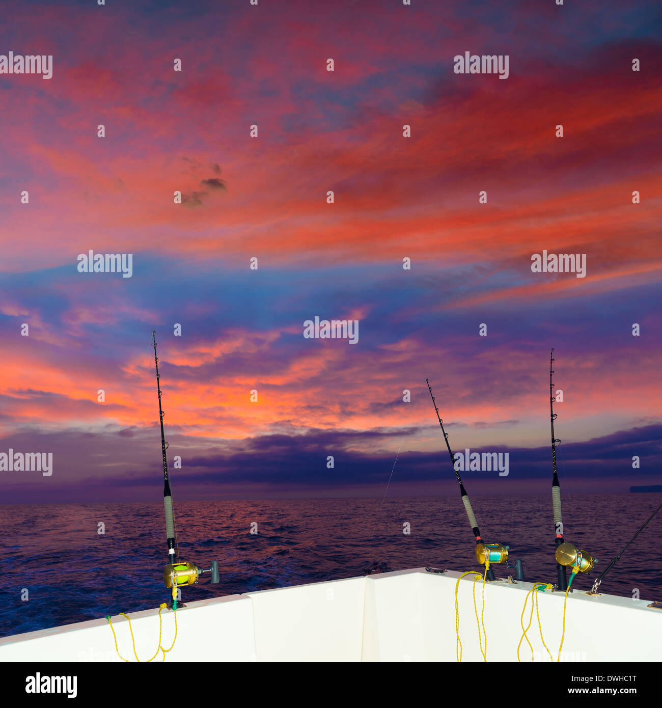 boat fishing trolling at sunset big game with rods and reels in ...