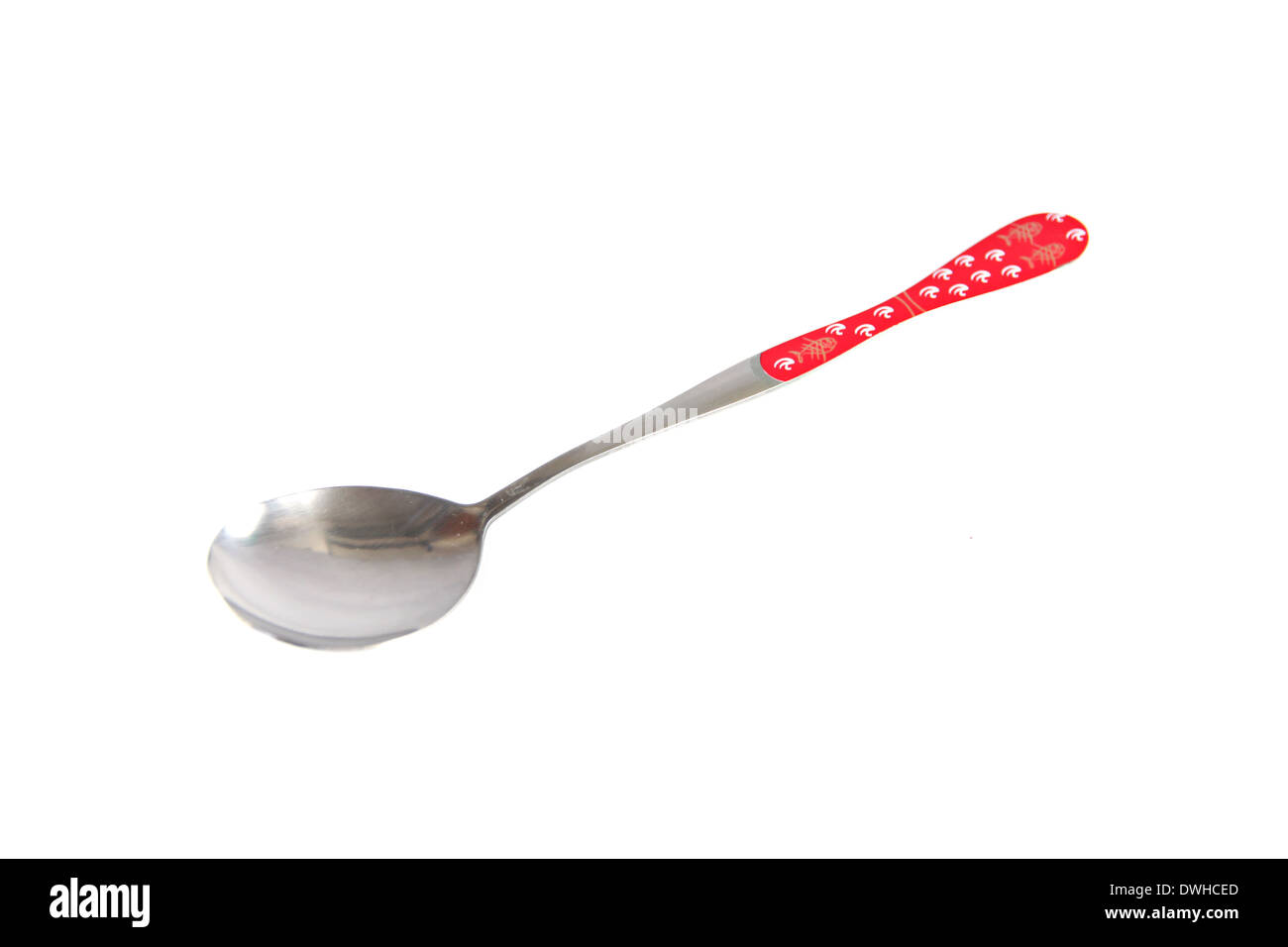 Stainless steel spoon with red pattern on white background Stock Photo ...