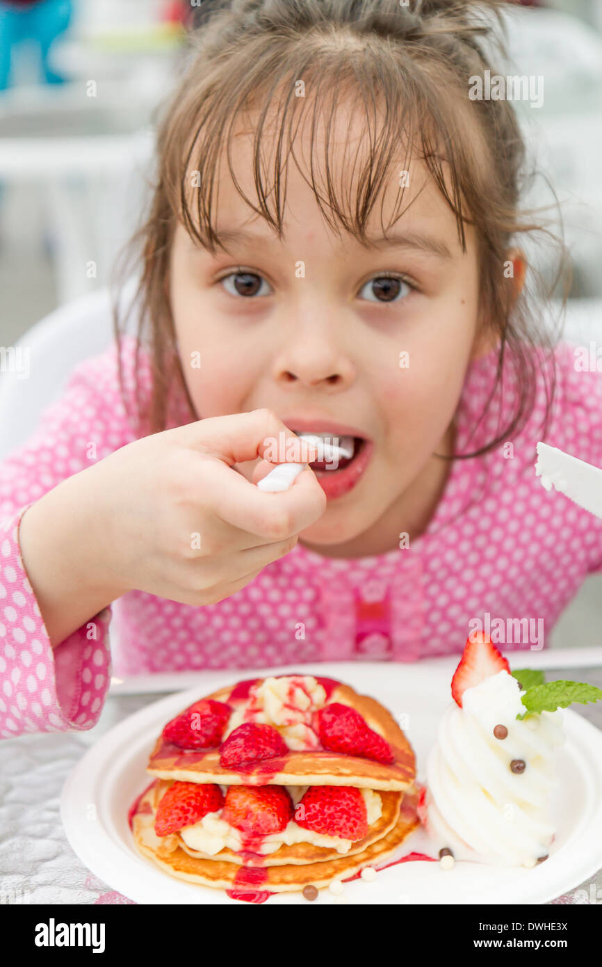 Girl eating a waffle hi-res stock photography and images - Alamy