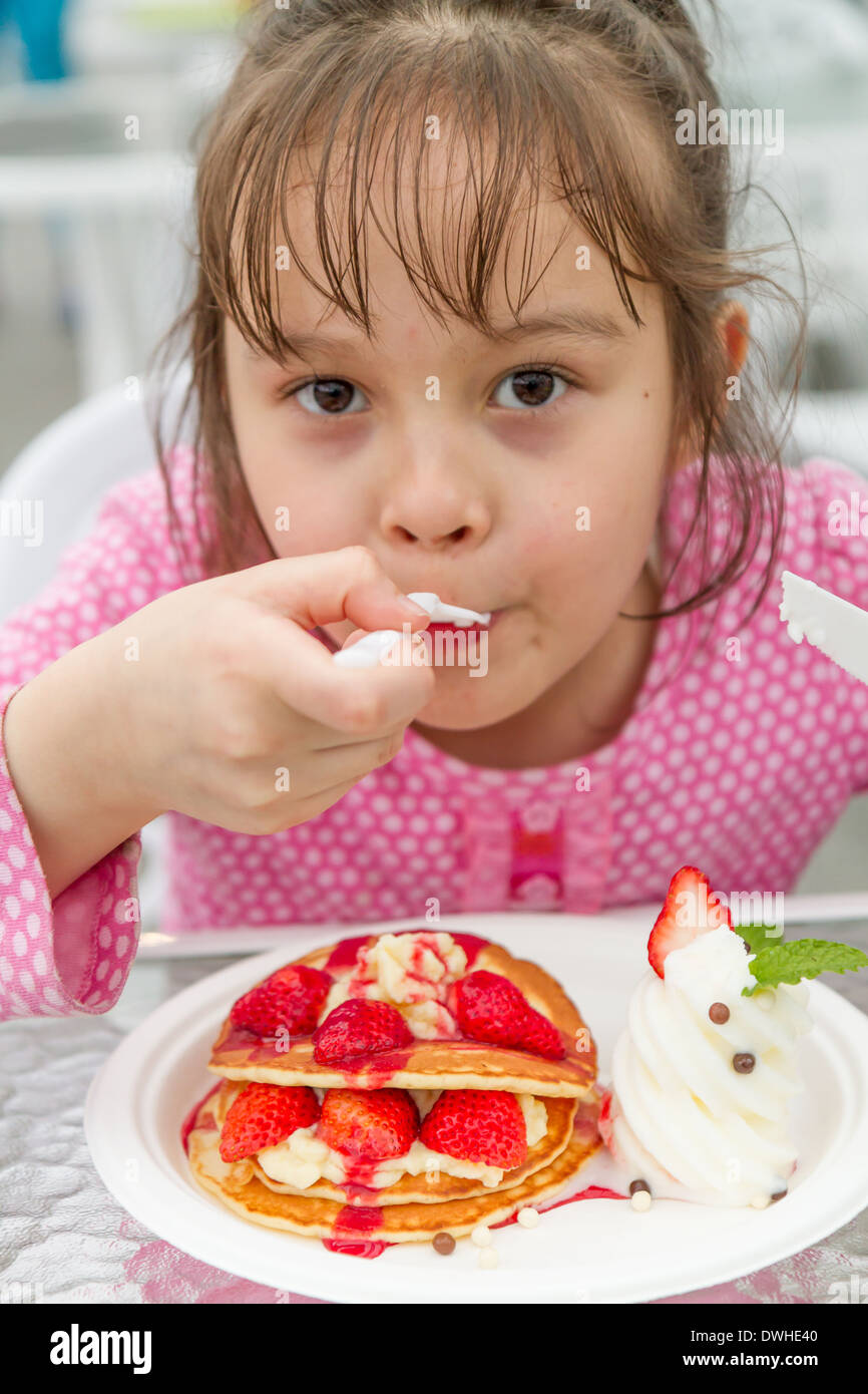 Pretty Asian Girl Eating a Strwaberry Waffle with ice cream Stock Photo ...