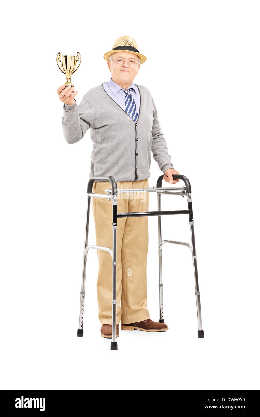 Full length portrait of elderly gentleman with walker holding a gold ...