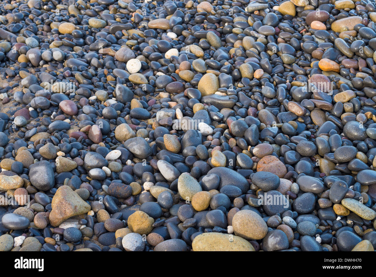 Full frame take of pebbles on a volcanic rock beach Stock Photo - Alamy