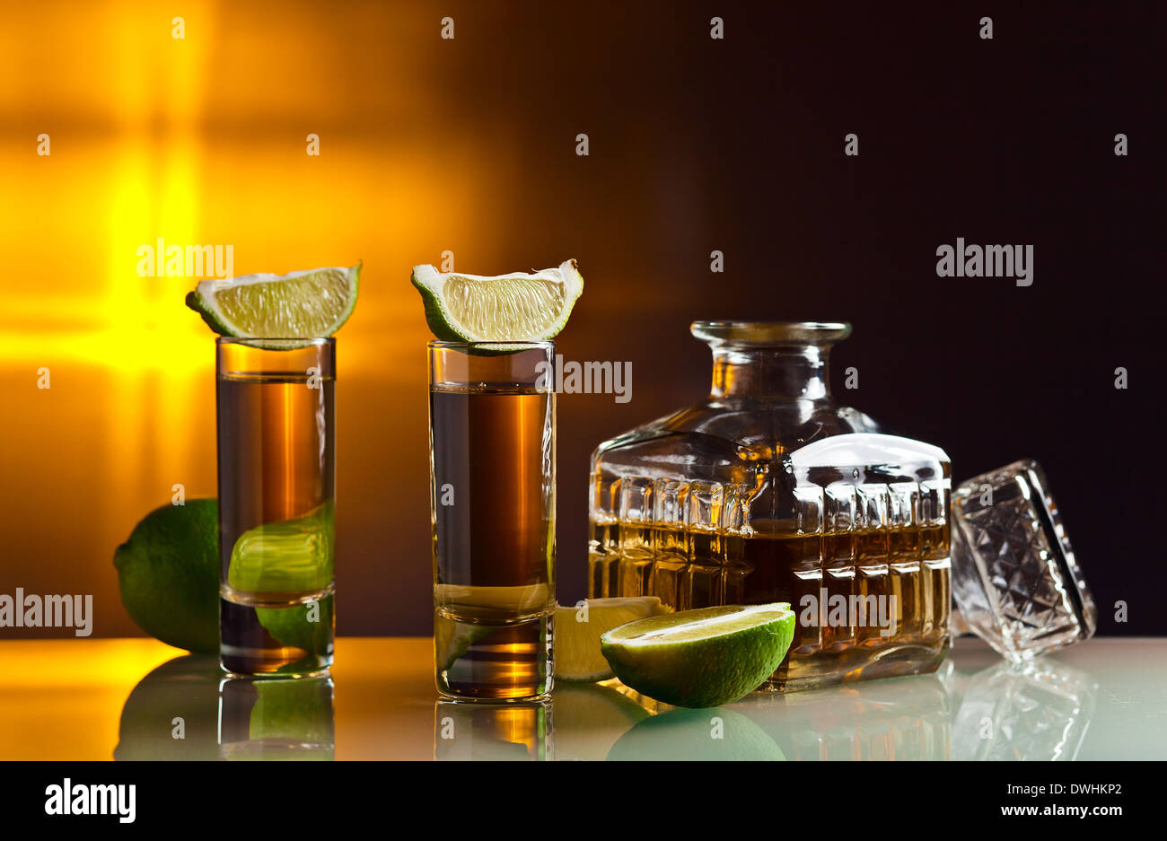 gold tequila and lime on a glass table Stock Photo - Alamy