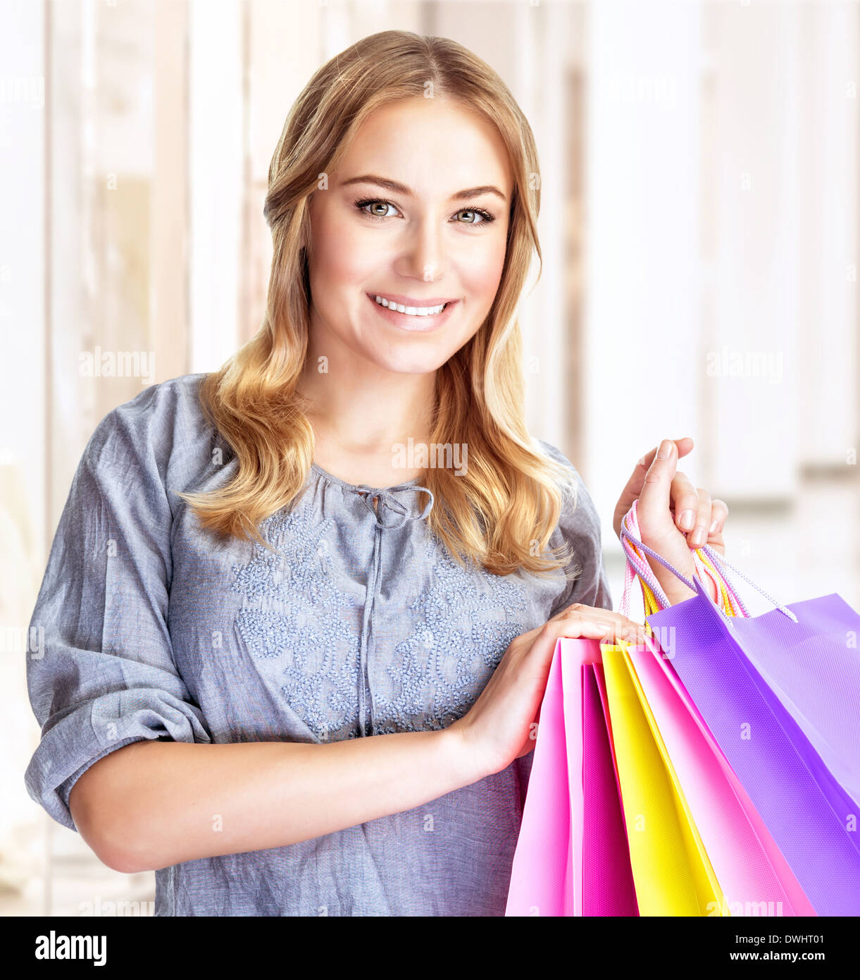 Closeup portrait of happy customer with colorful paper bag in great ...