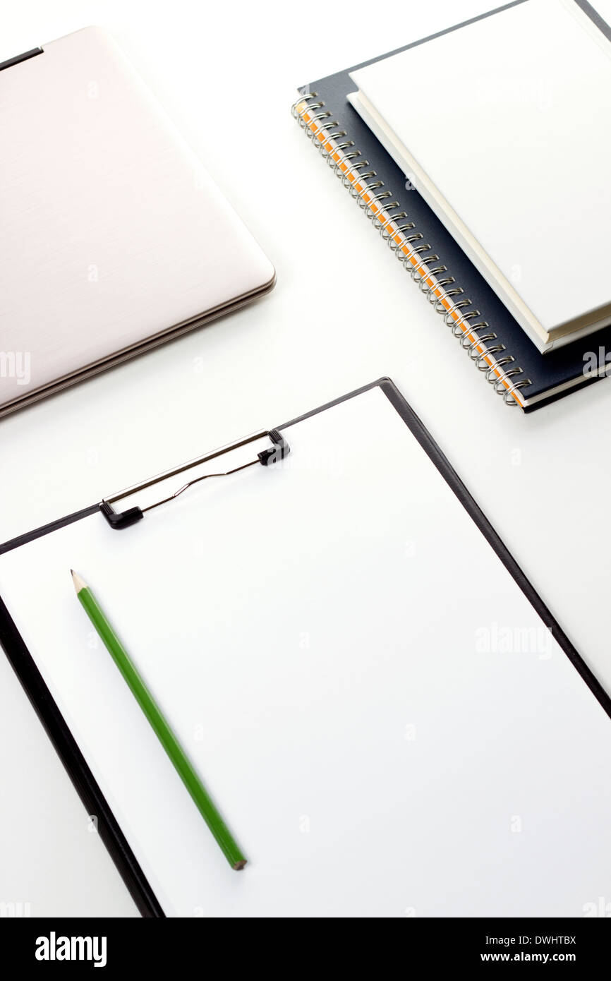 empty page with pencil and closed pc on white Stock Photo - Alamy