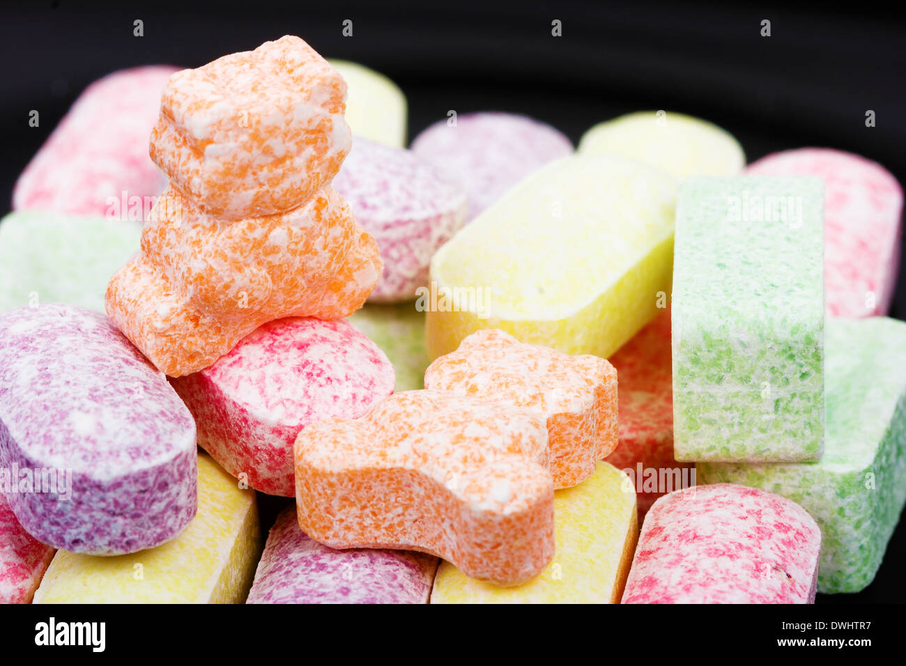 colorful different shapes candy on a black background Stock Photo - Alamy