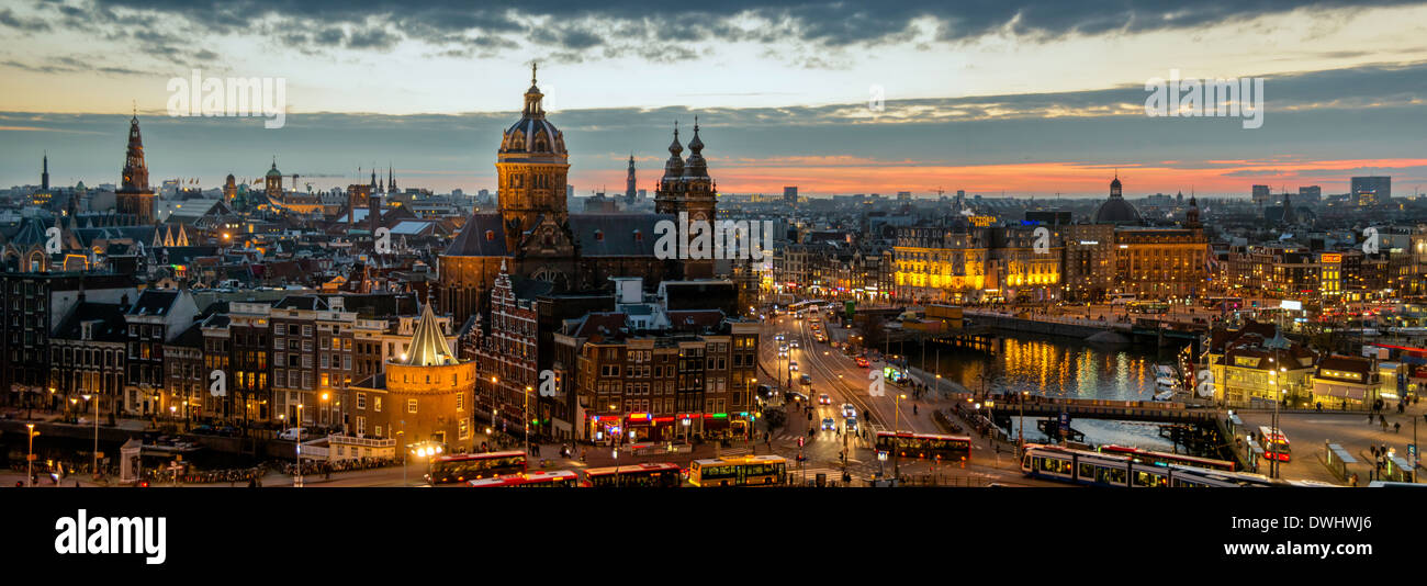 Panoramic view of Amsterdam skyline at sunset with city lights trams ...