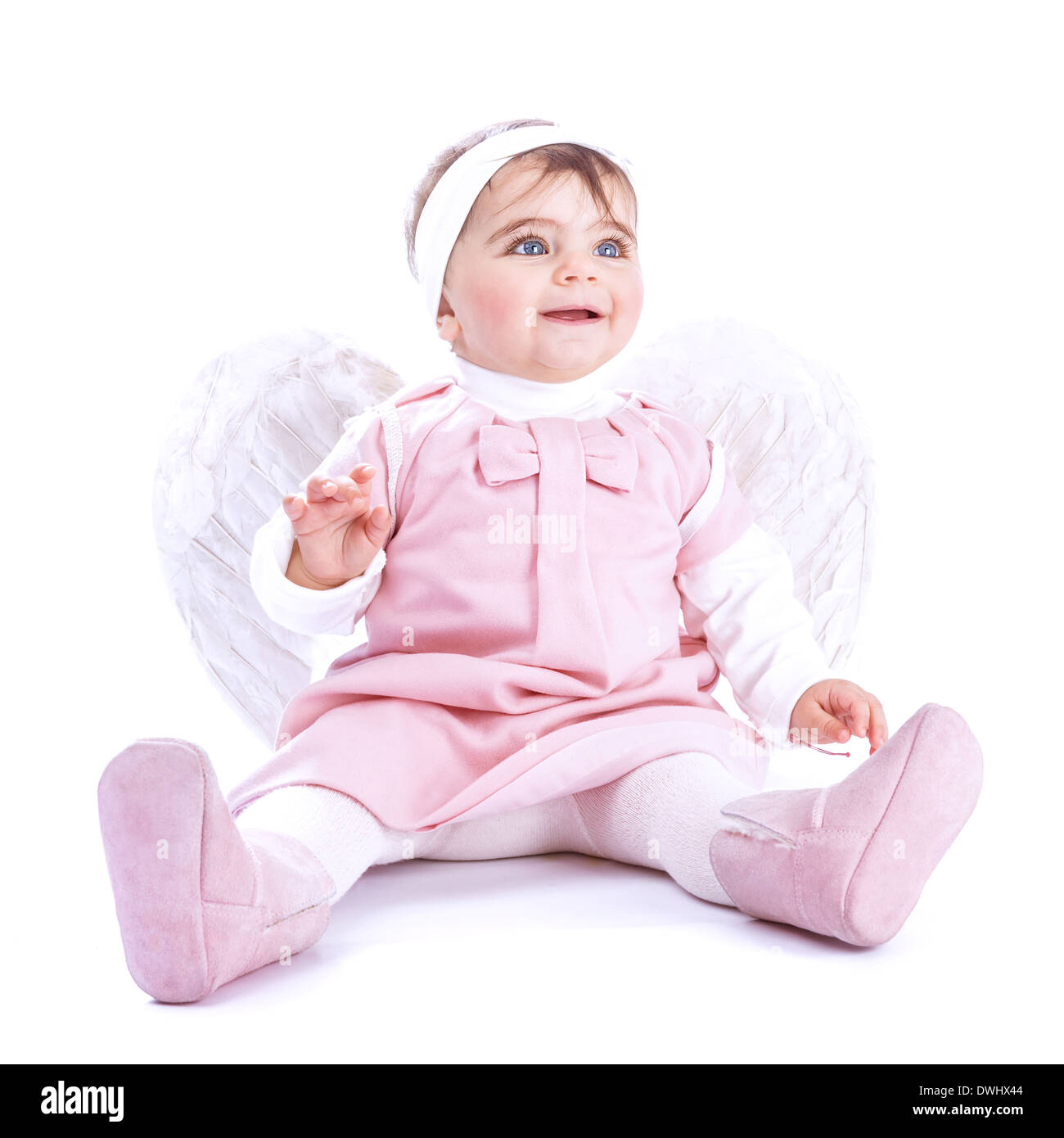 Angelic baby sitting in the studio isolated on white background, cute ...