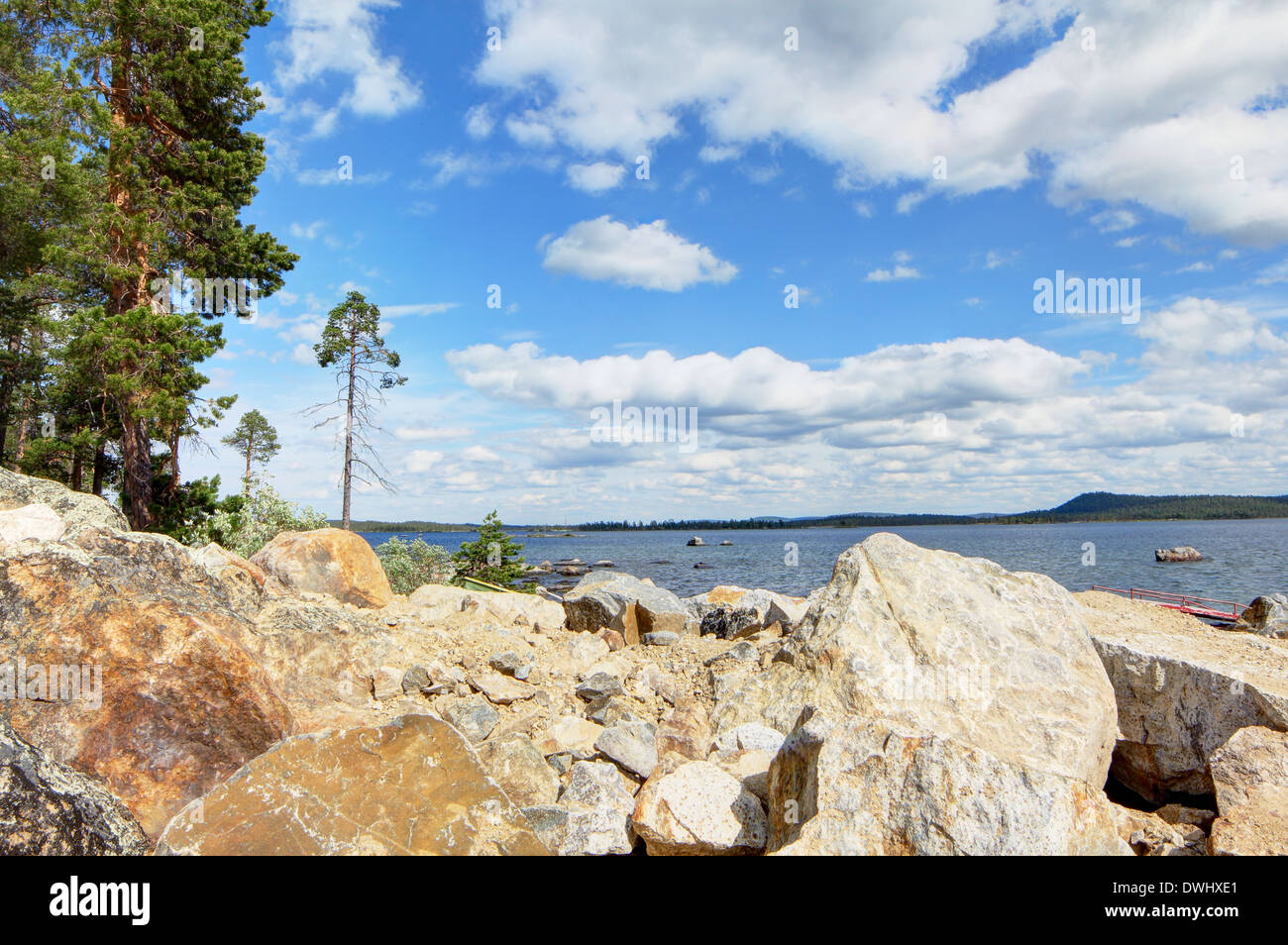 Beautiful landscape with lake shore, stones and pines Stock Photo - Alamy