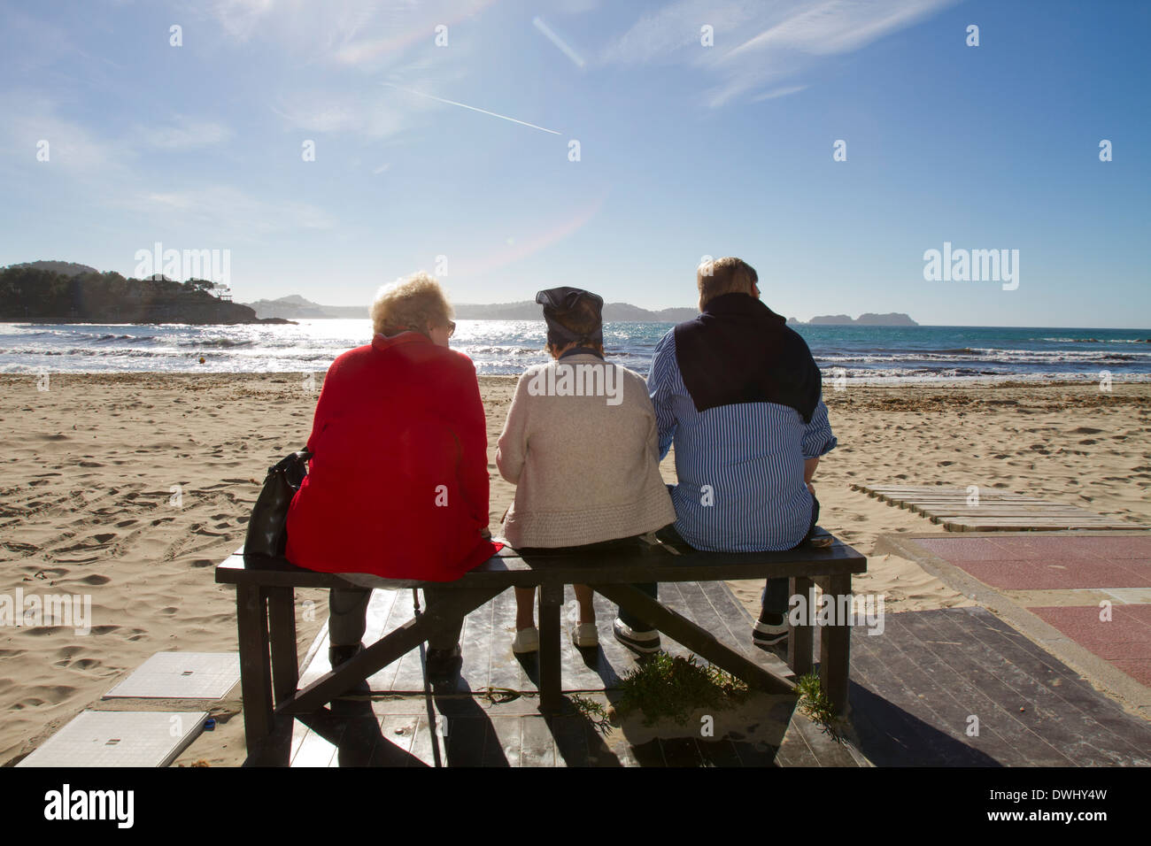 Three seniors sitting promenade sand beach Mallorca Paguera beach ...