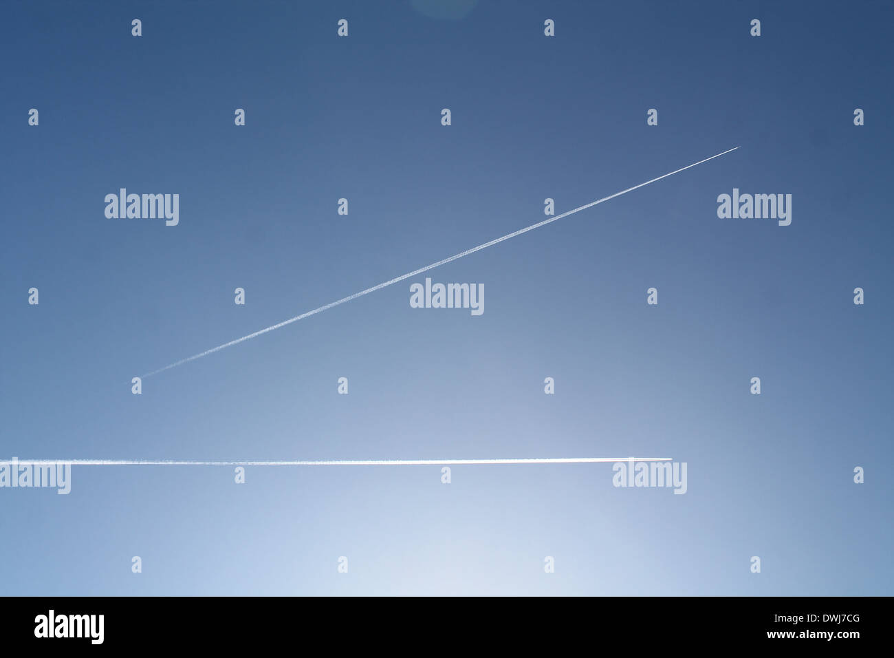 lines white trace after airplanes into the sky Stock Photo - Alamy