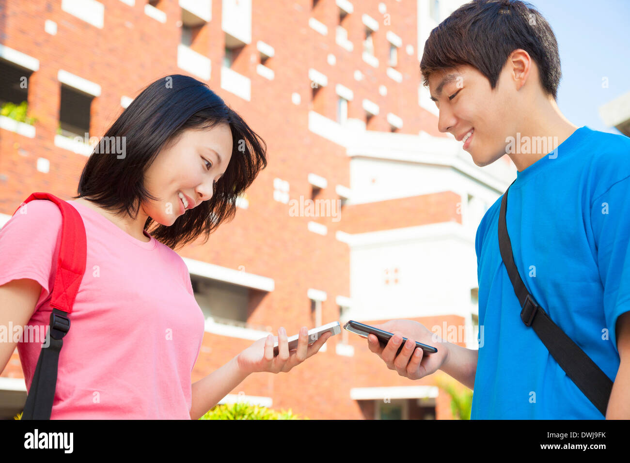 young students are using smartphones to show something at school Stock ...