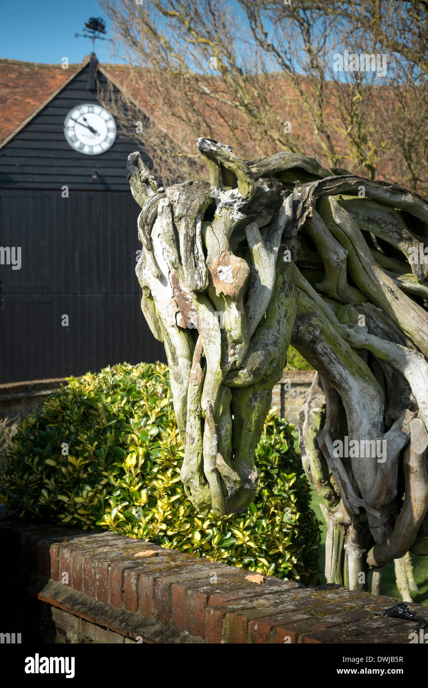 Wooden horse made out of tree branches outside a converted barn ...