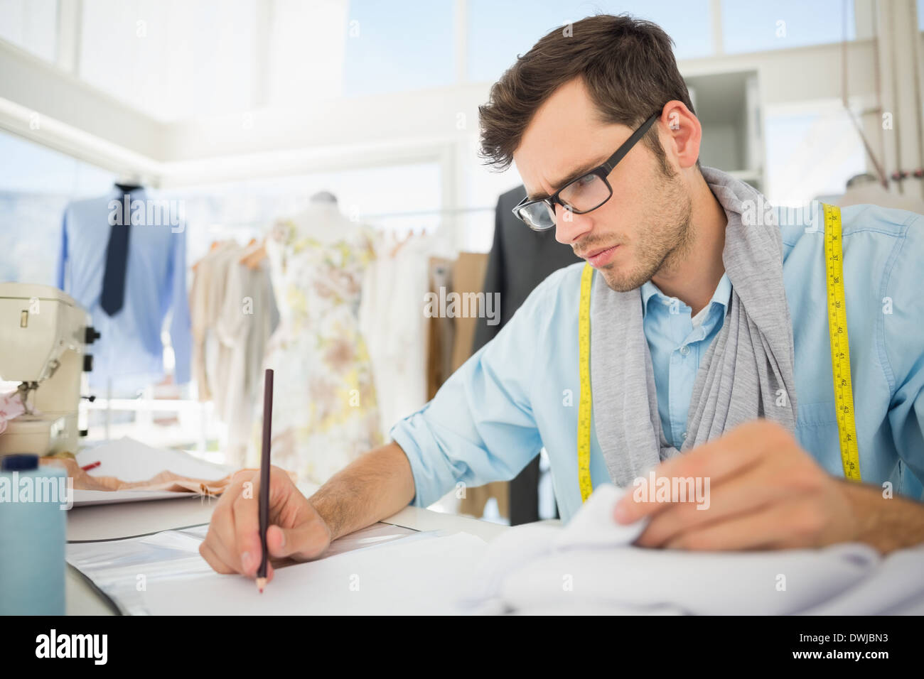 Fashion designer working on his designs Stock Photo - Alamy
