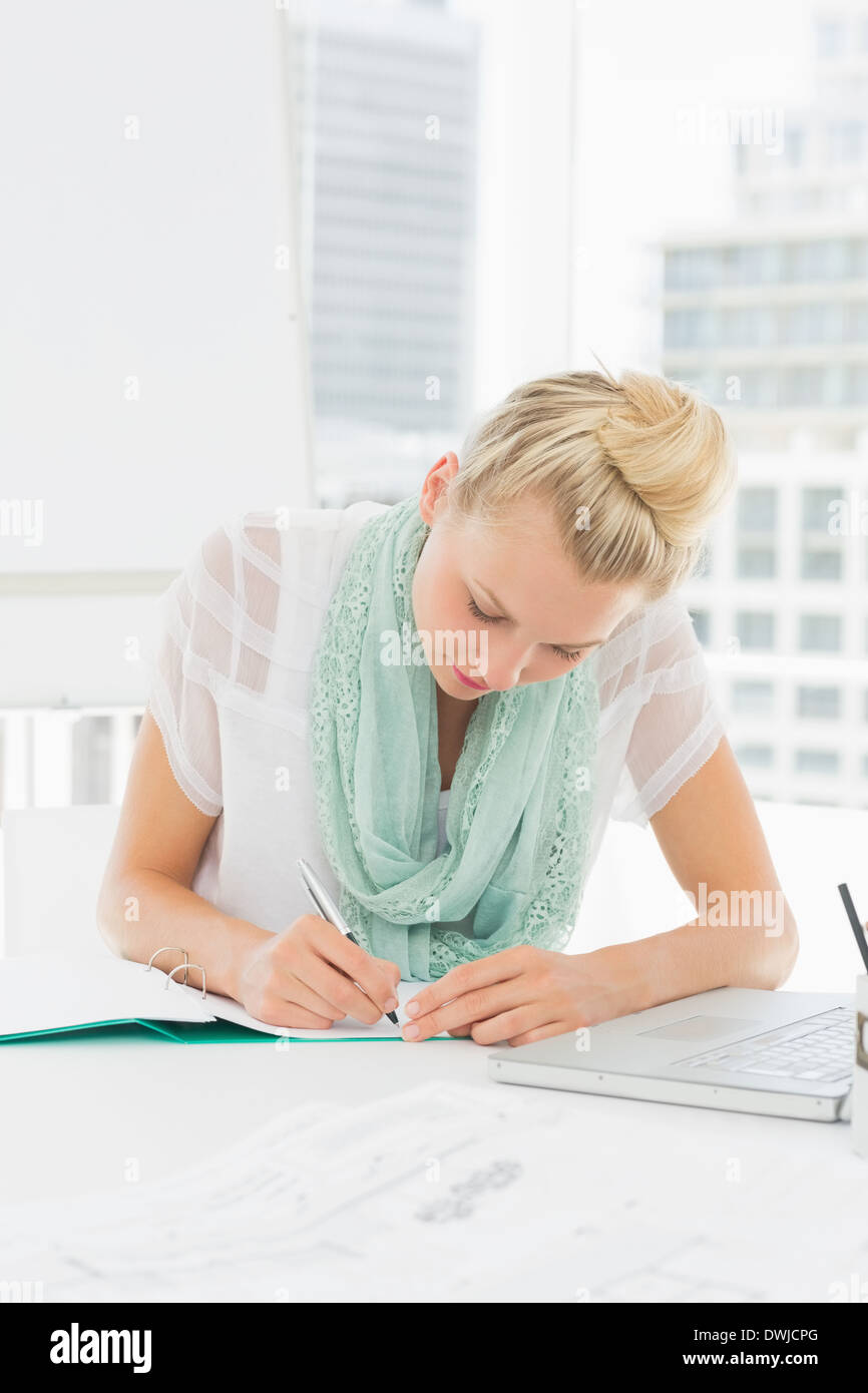 Casual young woman writing notes Stock Photo - Alamy