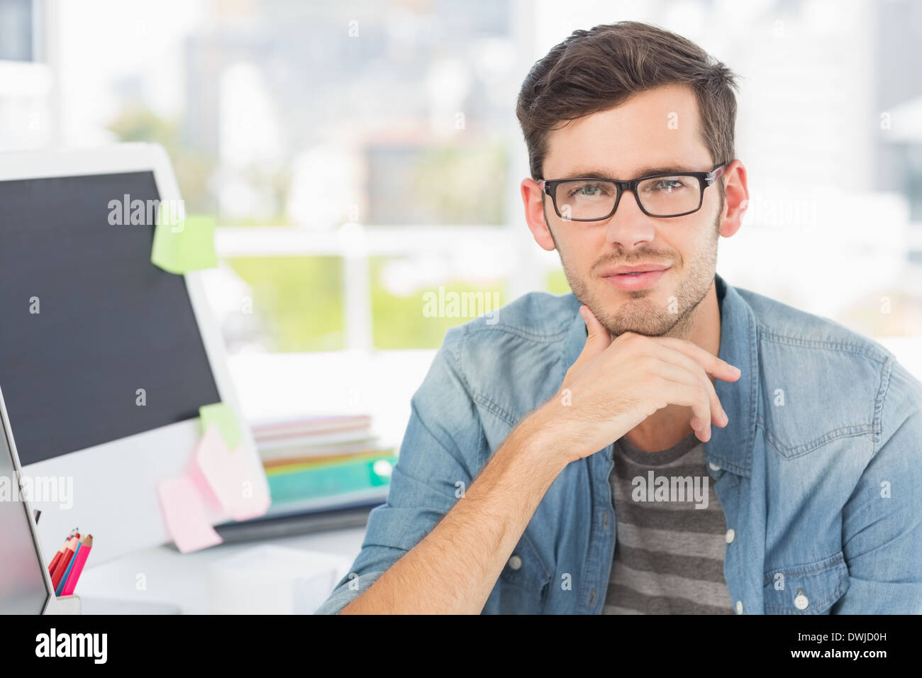 Casual male photo editor at a bright office Stock Photo - Alamy