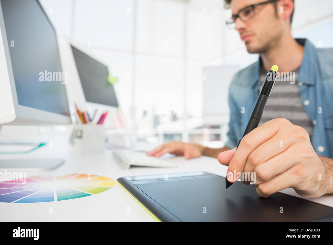 Casual male photo editor using graphics tablet Stock Photo - Alamy