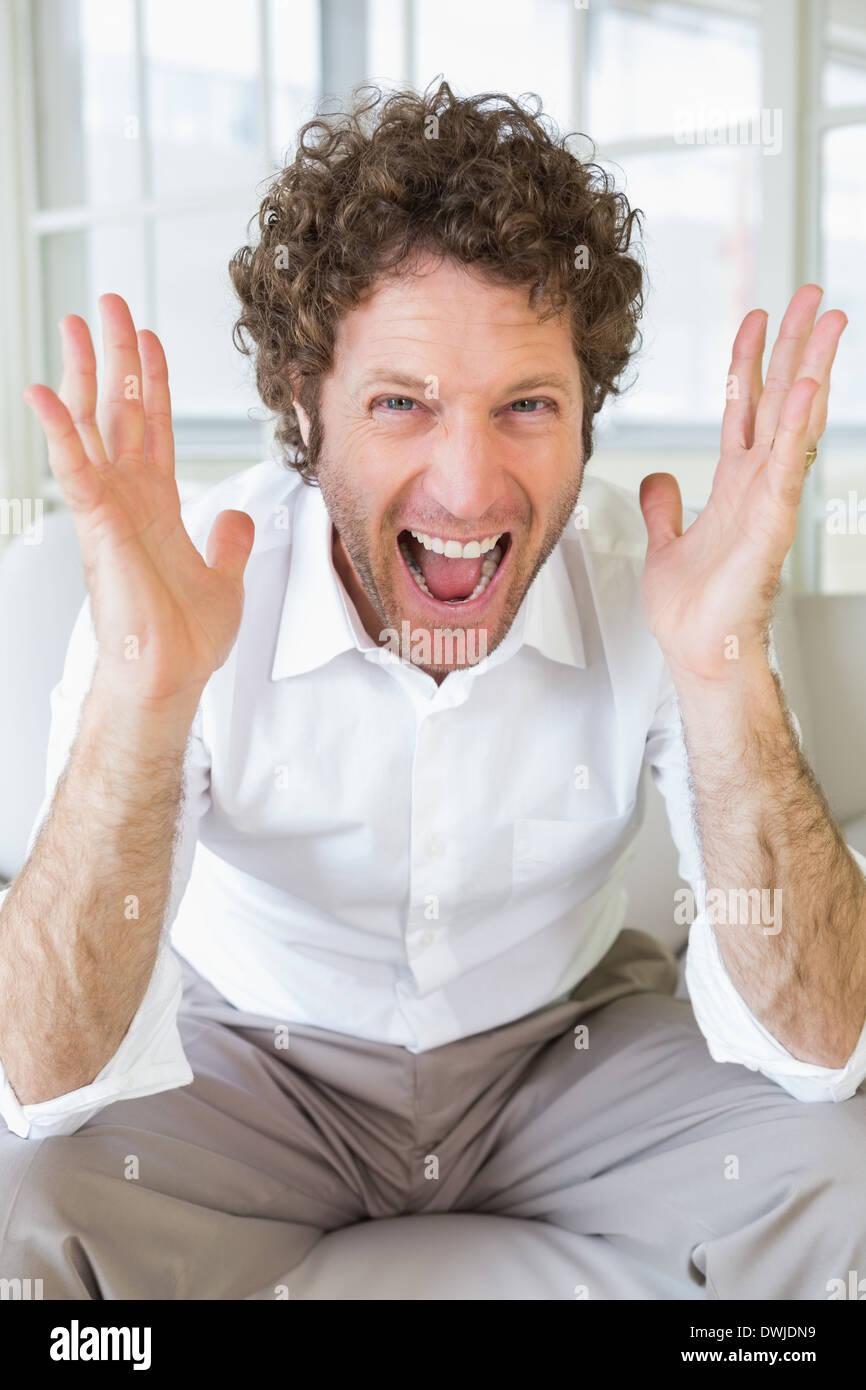 Worried well dressed man shouting at home Stock Photo - Alamy