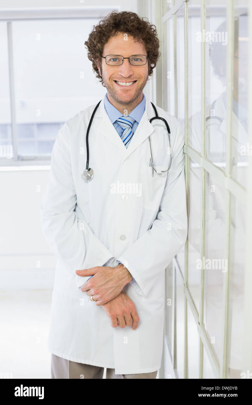Happy handsome male doctor standing in hospital Stock Photo - Alamy