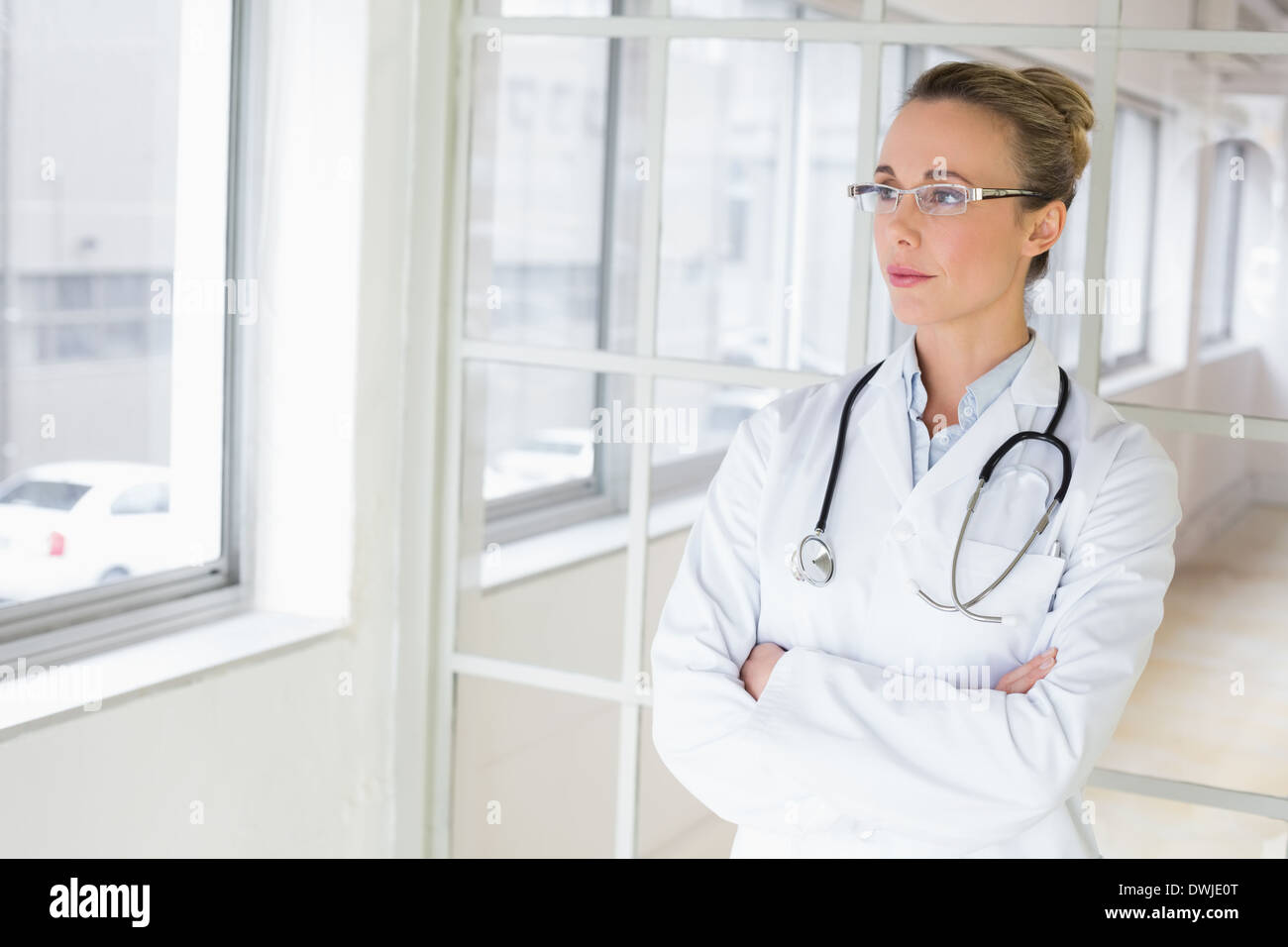Serious female doctor with arms crossed in hospital Stock Photo - Alamy