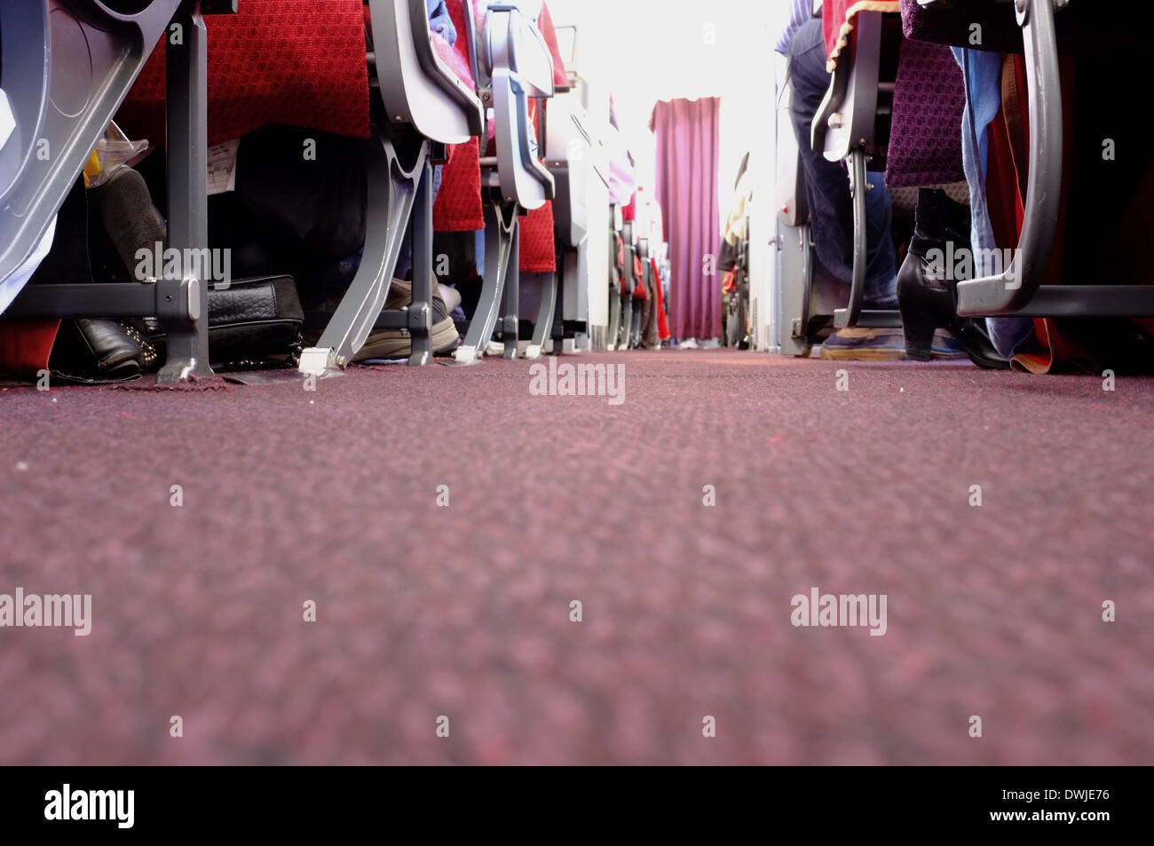 Passenger jet aisle at foot level Stock Photo - Alamy