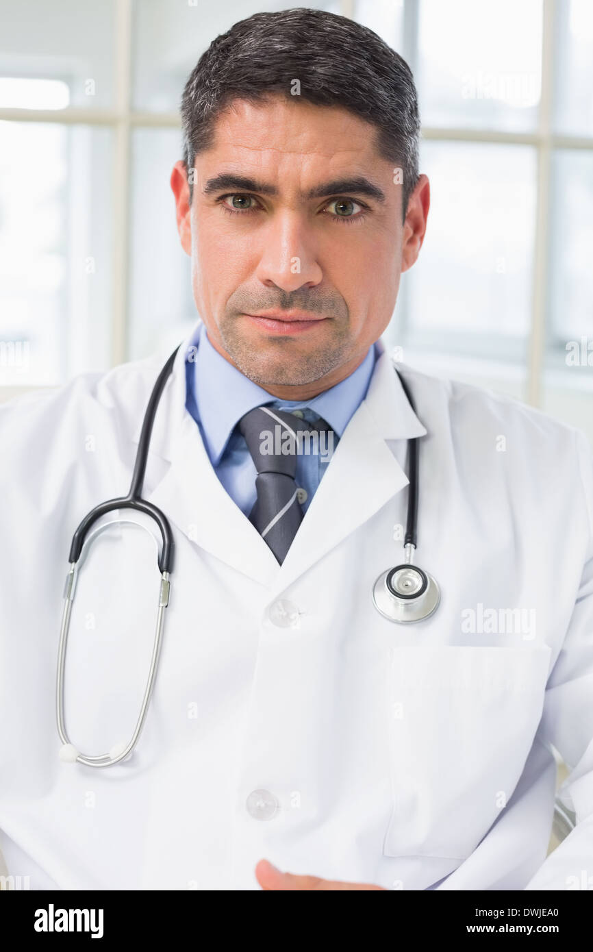 Portrait of a serious male doctor standing in the hospital Stock Photo ...