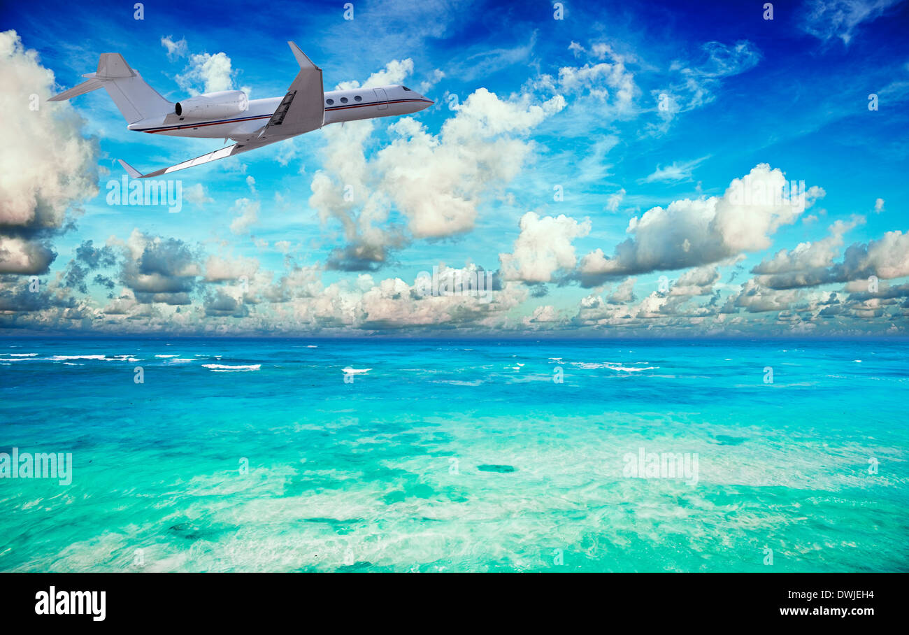 Private jet over the tropical sea Stock Photo - Alamy