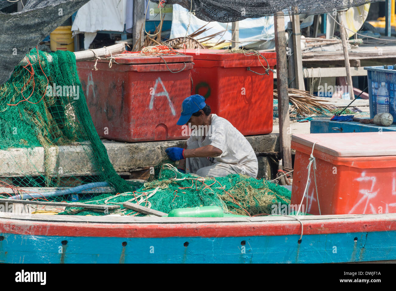 Fisherman mending his nets hi-res stock photography and images - Alamy