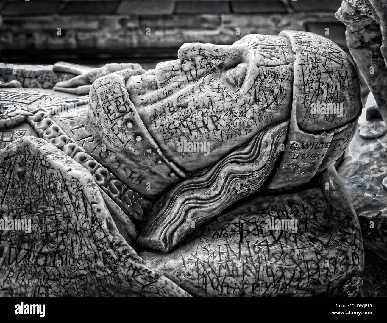 Graffiti-covered marble sculpture of knight on an historic tomb in UK ...
