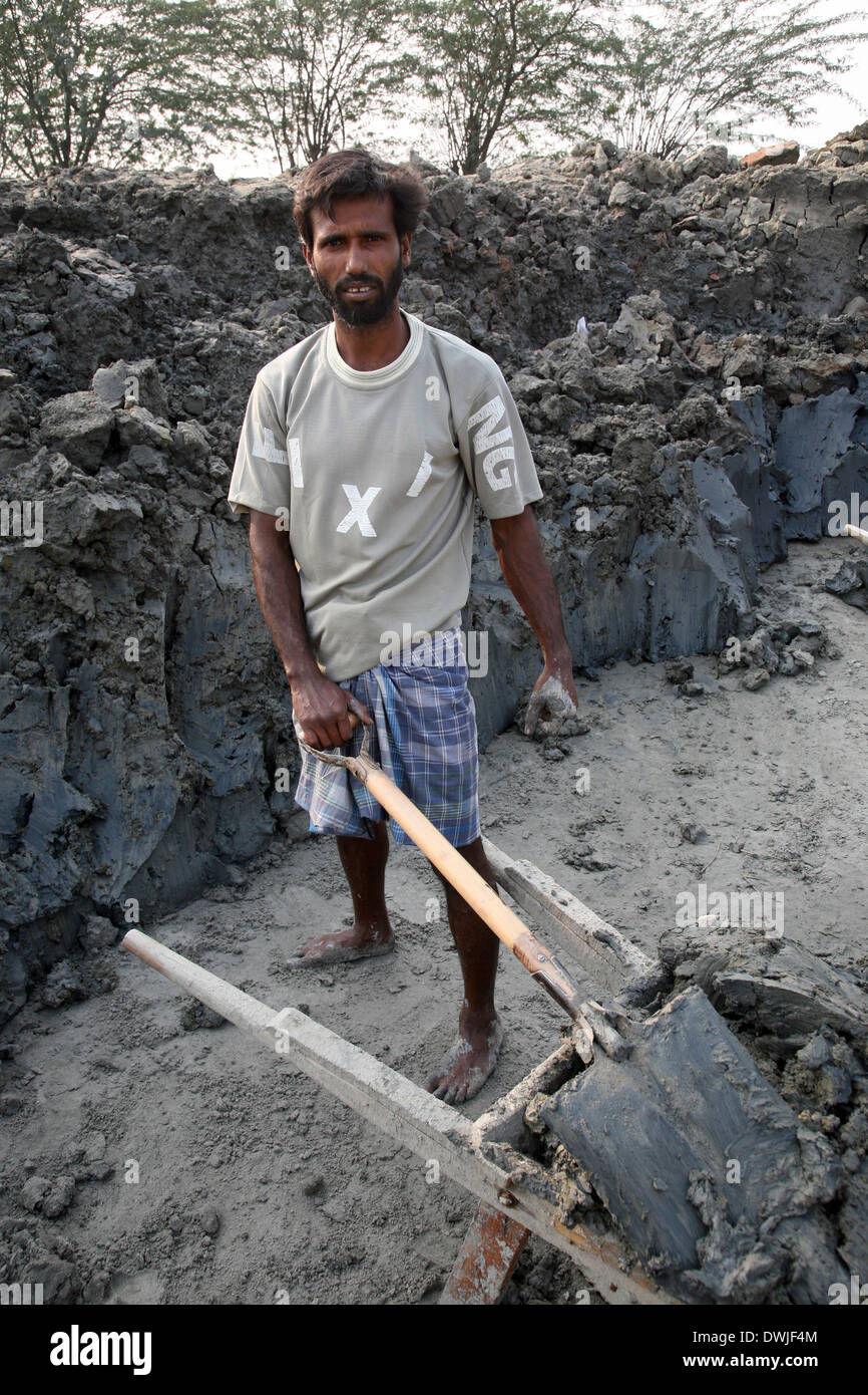 Brick field. Laborers are carrying deposited soil for making raw brick ...