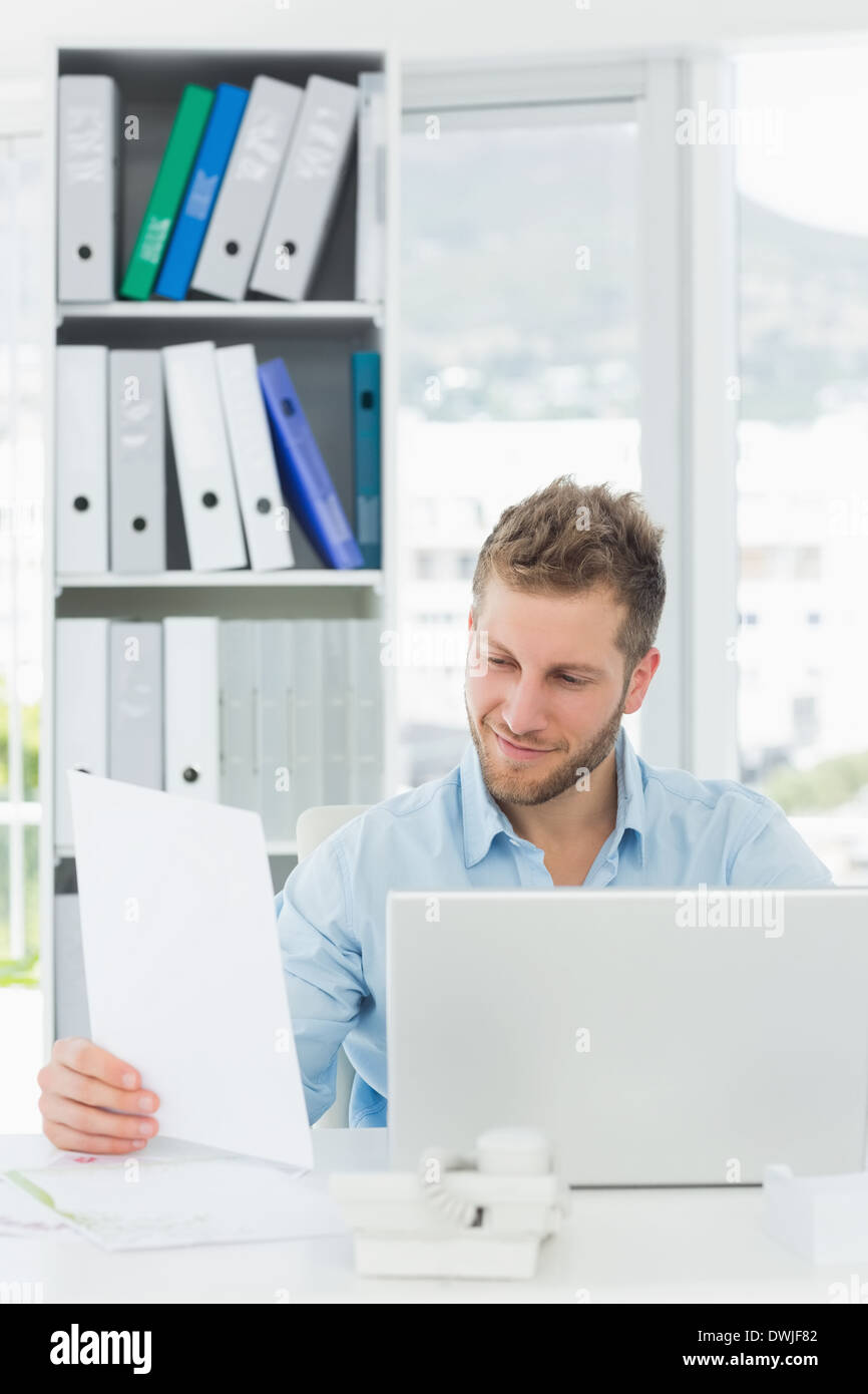 Handsome man working at his desk in creative office Stock Photo - Alamy