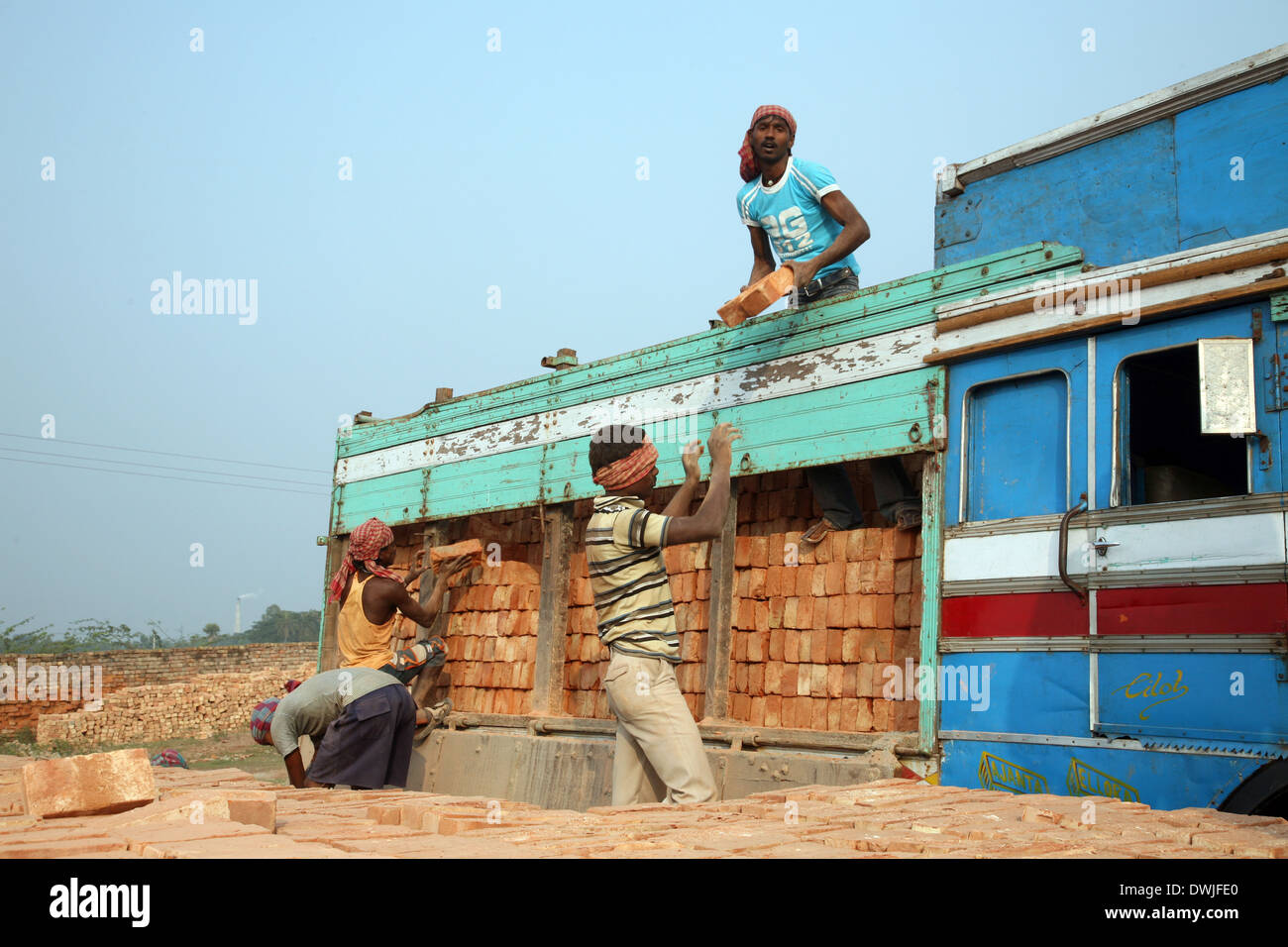 Brick field workers carrying complete finish brick from the kiln, and ...