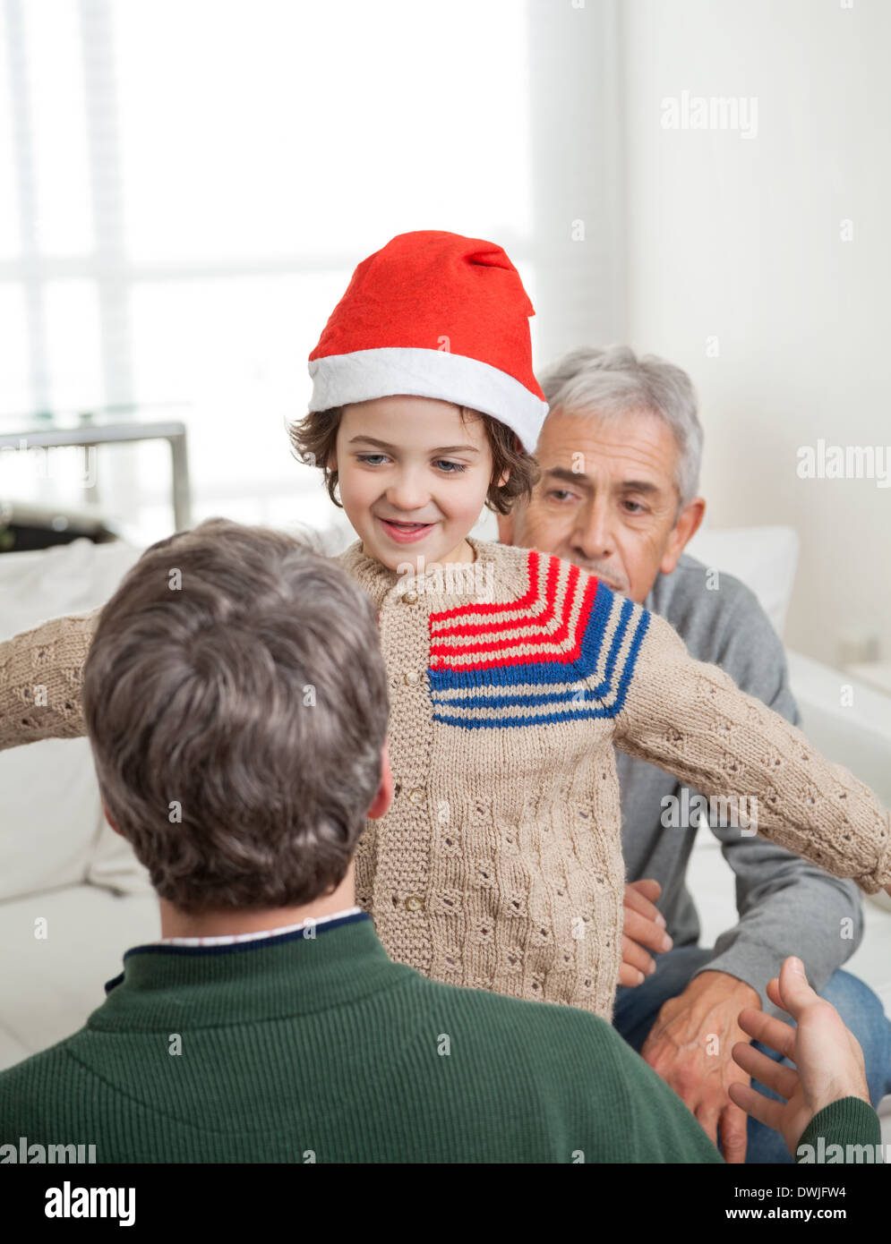Son In Santa Hat About To Embrace Father Stock Photo - Alamy