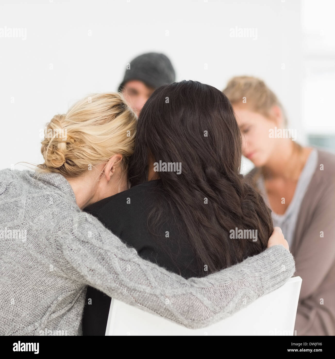 Women hugging in rehab group Stock Photo - Alamy