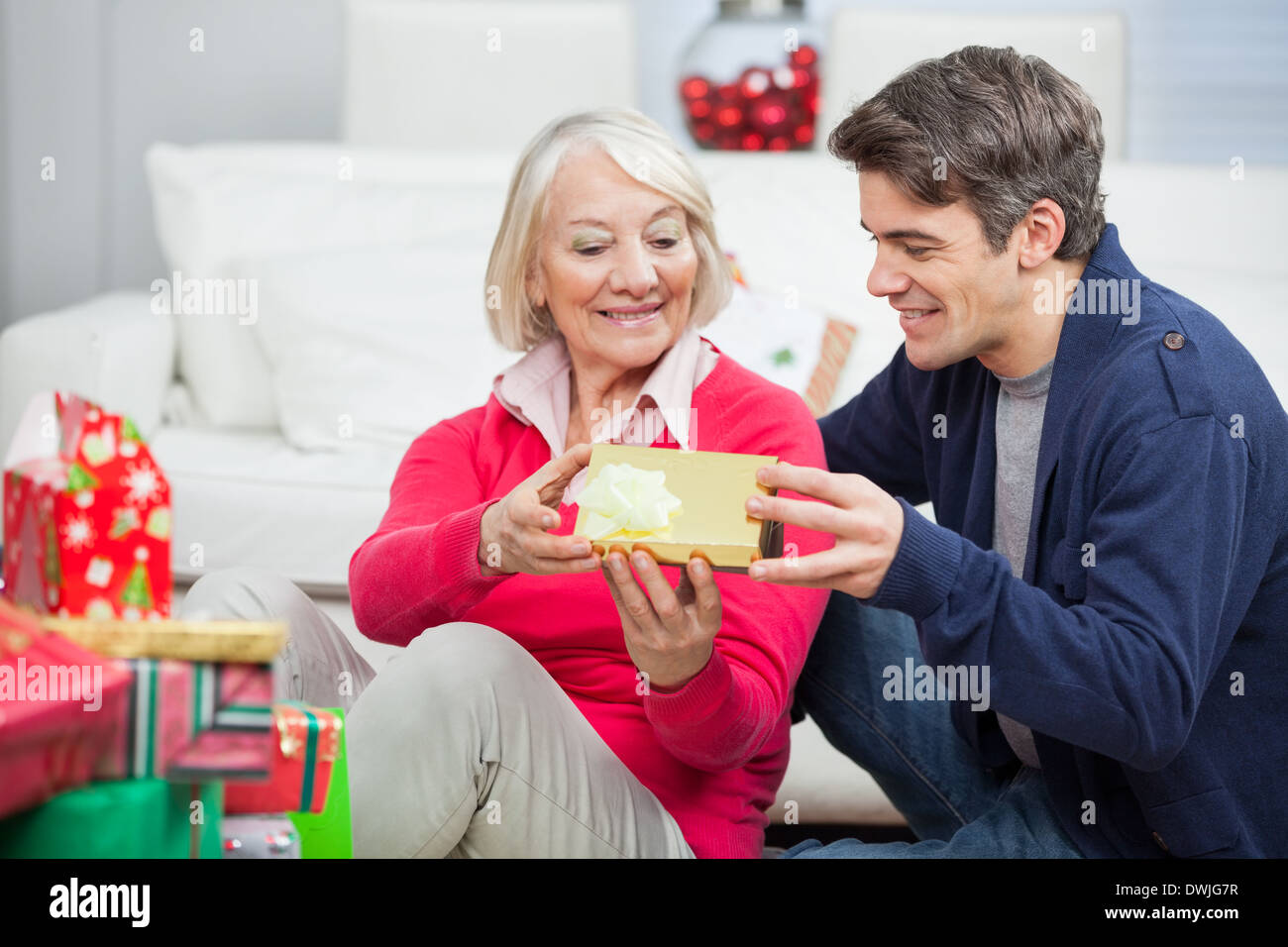 Son Giving Christmas Gift To Mother Stock Photo - Alamy