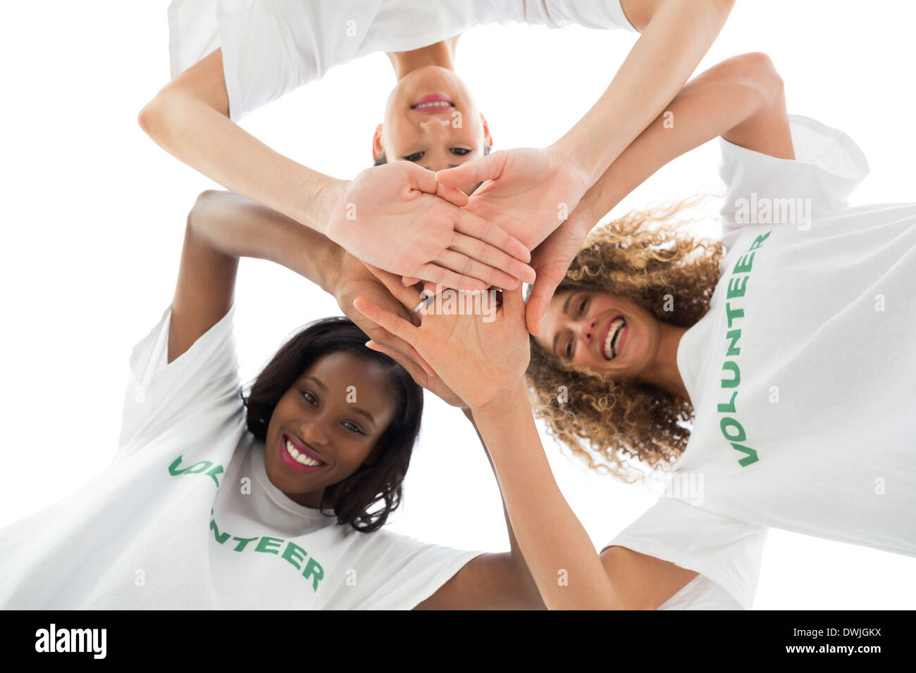 Group volunteers putting hands hi-res stock photography and images - Alamy